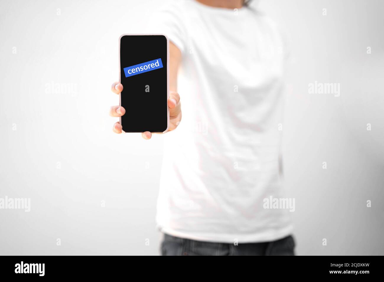 woman with phone and censored text on it. Social media censorship ...
