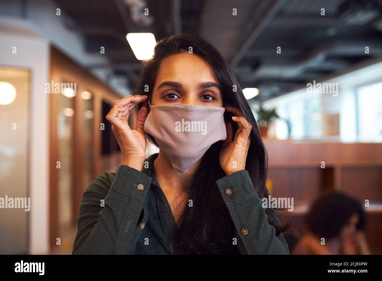Portrait Of Businesswoman Wearing Face Mask In Modern Open Plan Office ...