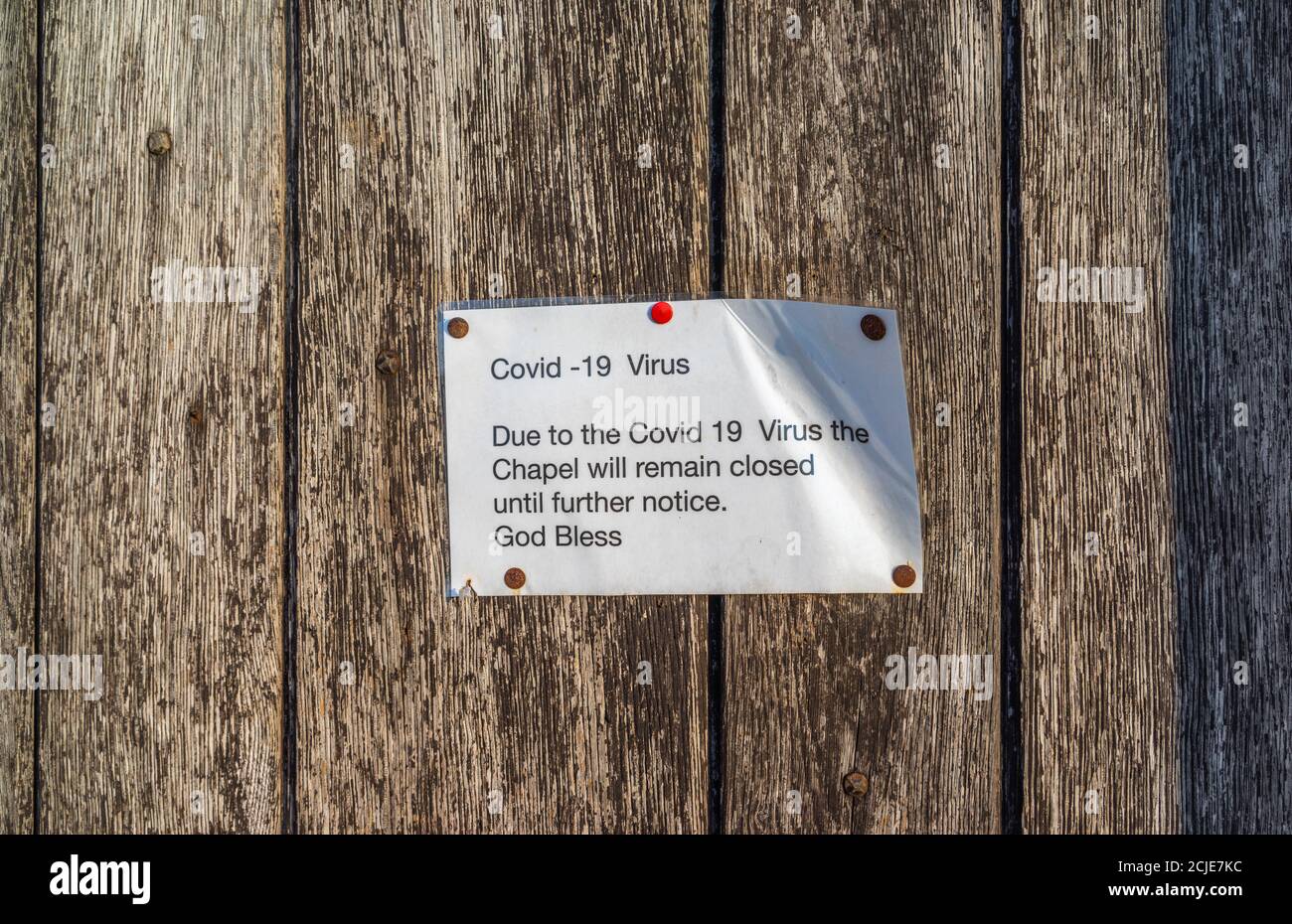 Covid-19 coronavirus notice of closure on the wooden entrance door to ...