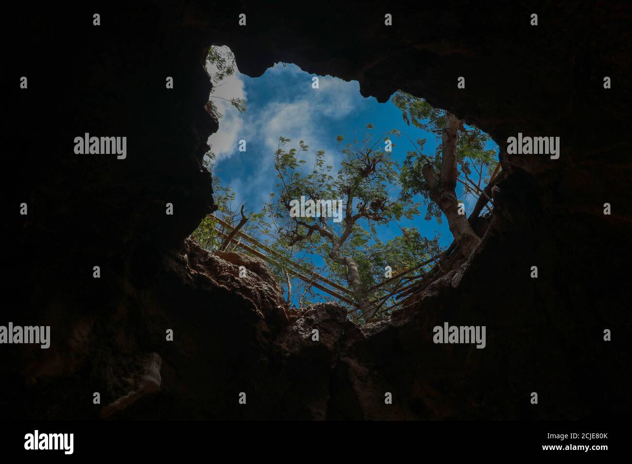 View from inside a cave looking out.Fallen cave ceiling. A hole in the ...