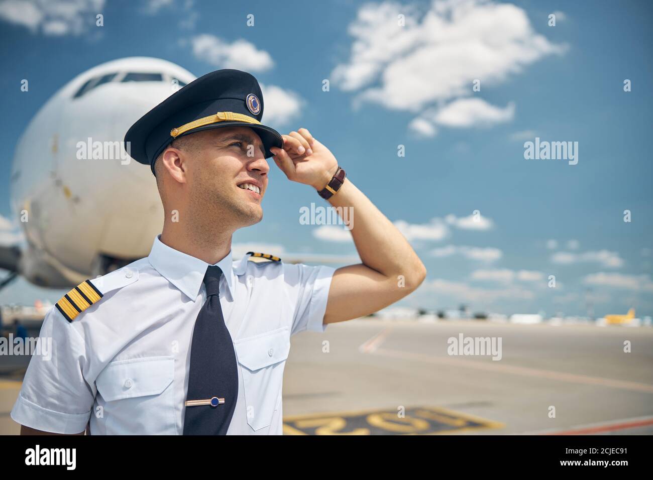 Handsome male pilot standing outdoors at airport Stock Photo - Alamy