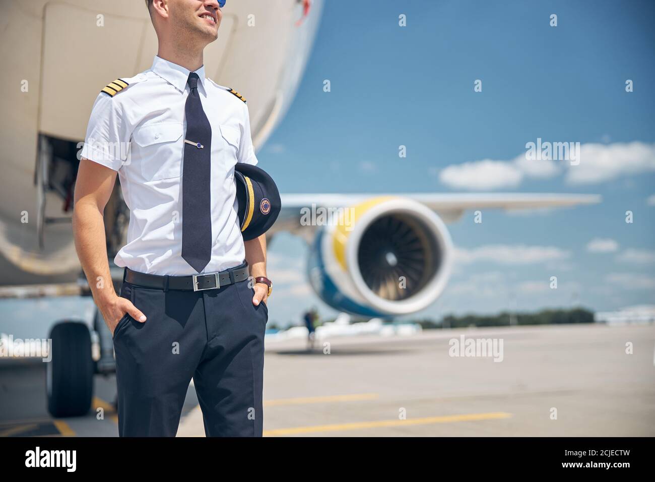 Smiling male pilot standing airplane hi-res stock photography and ...
