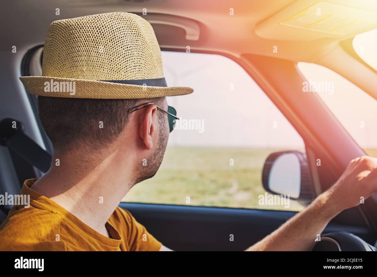 Young handsome man in straw hat driving car Stock Photo - Alamy