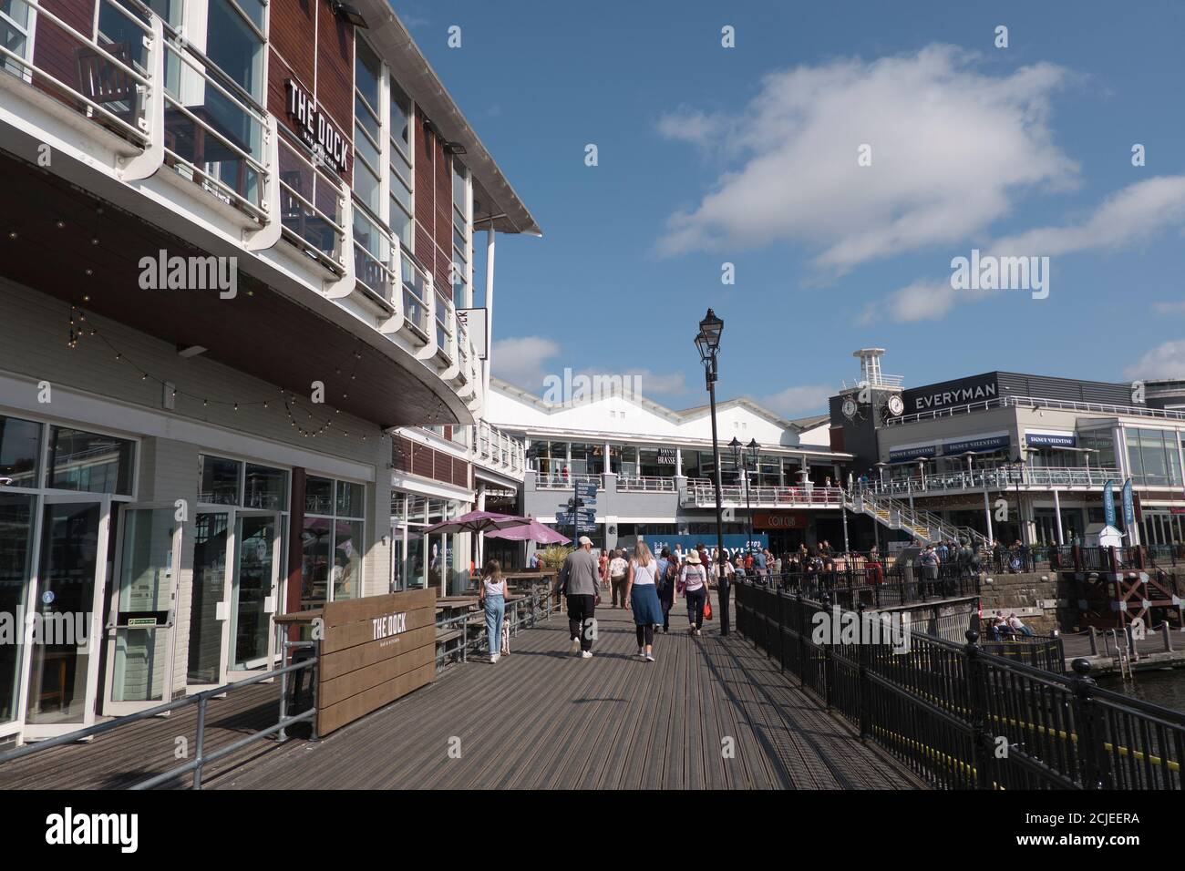 Visitors enjoying a Sunday midday stroll along Mermaid Quay in Cardiff ...