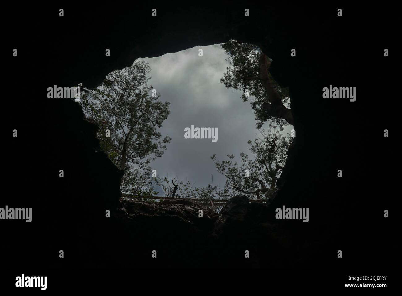 View from inside a cave looking out.Fallen cave ceiling. A hole in the ...
