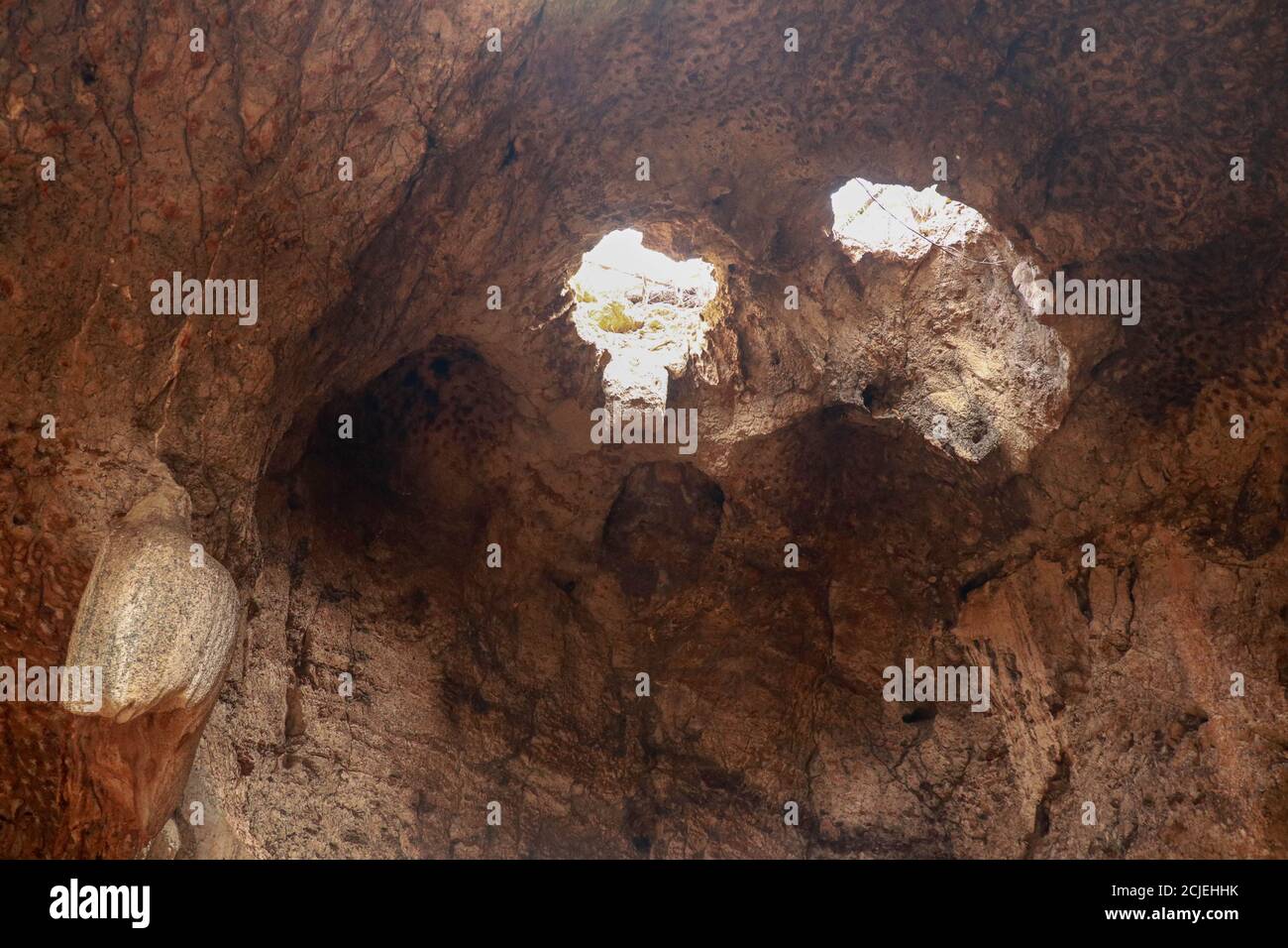 High angle view of rock formation. Fallen cave ceiling. A hole in the ...