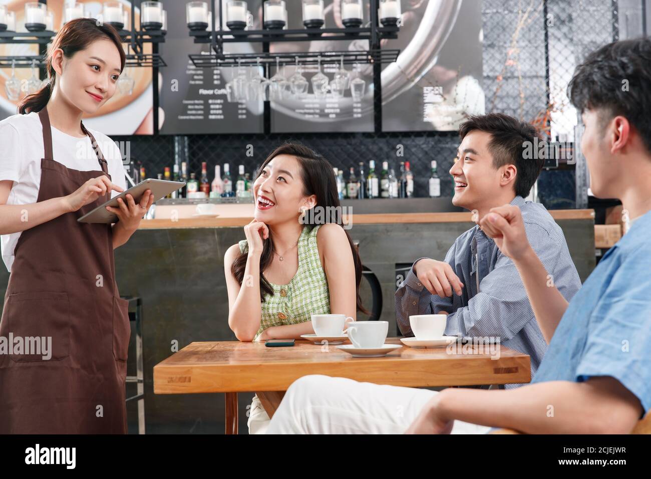 Young friends in a cafe Stock Photo - Alamy