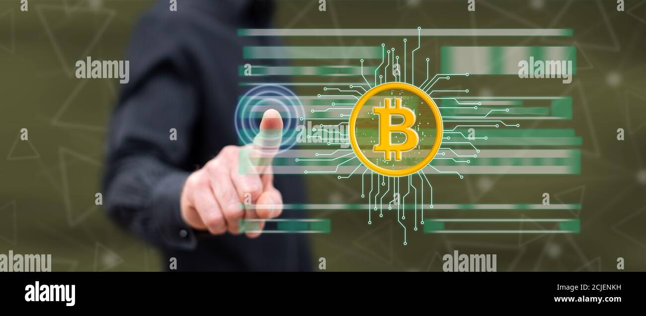 Man touching a bitcoin currency concept on a touch screen with his ...