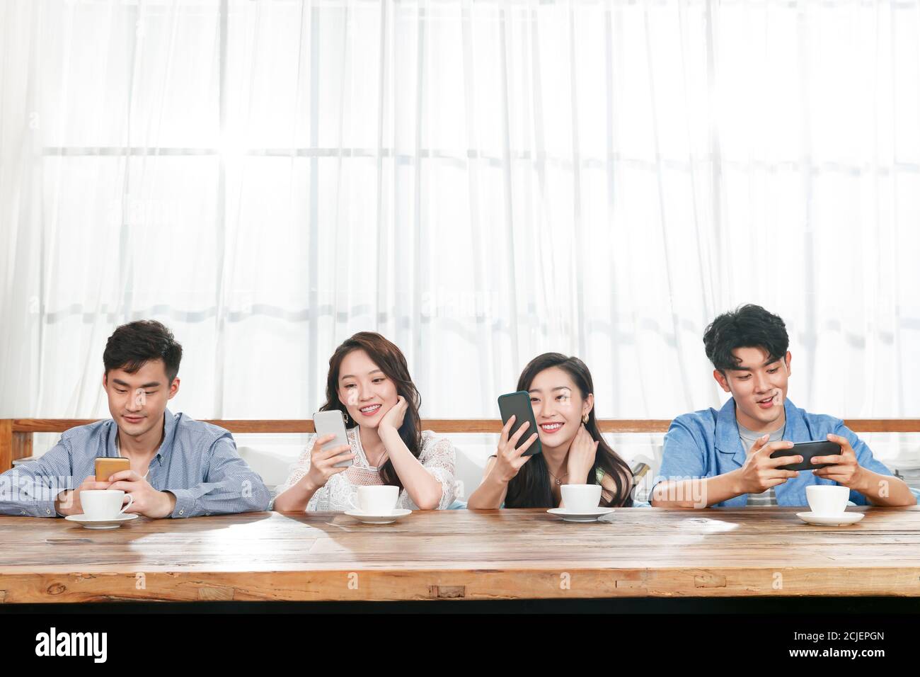 Four chinese friends using hi-res stock photography and images - Alamy