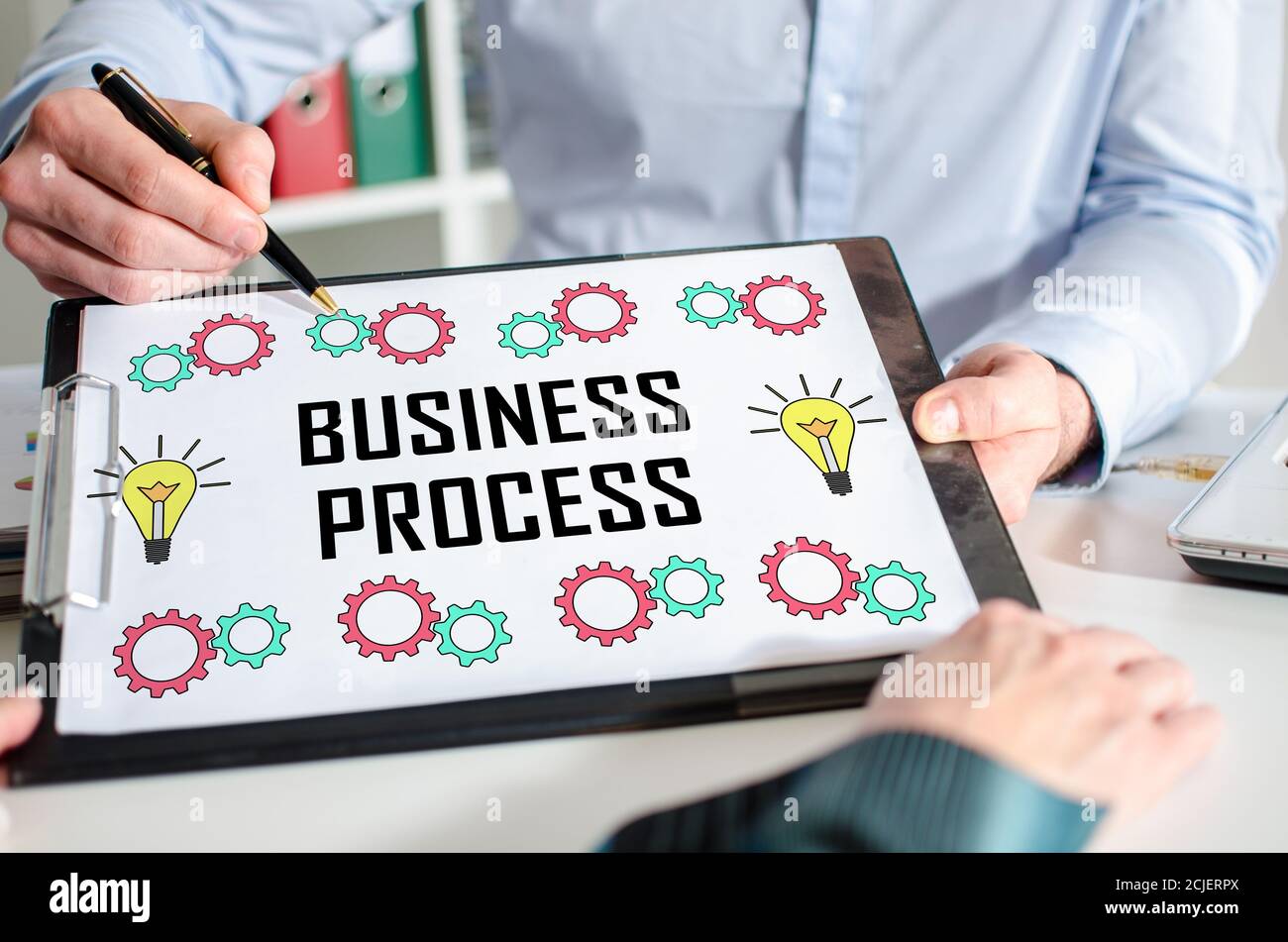 Businessman showing business process concept on a clipboard Stock Photo ...