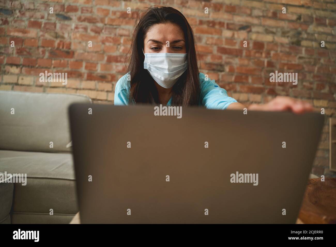 Long-haired woman staring at the laptop screen Stock Photo - Alamy