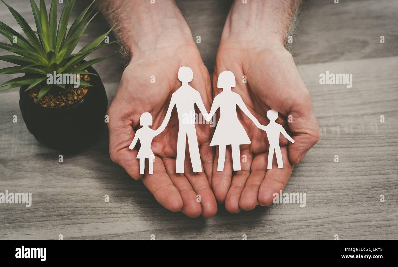 Hands protecting a family; symbol of life insurance Stock Photo - Alamy
