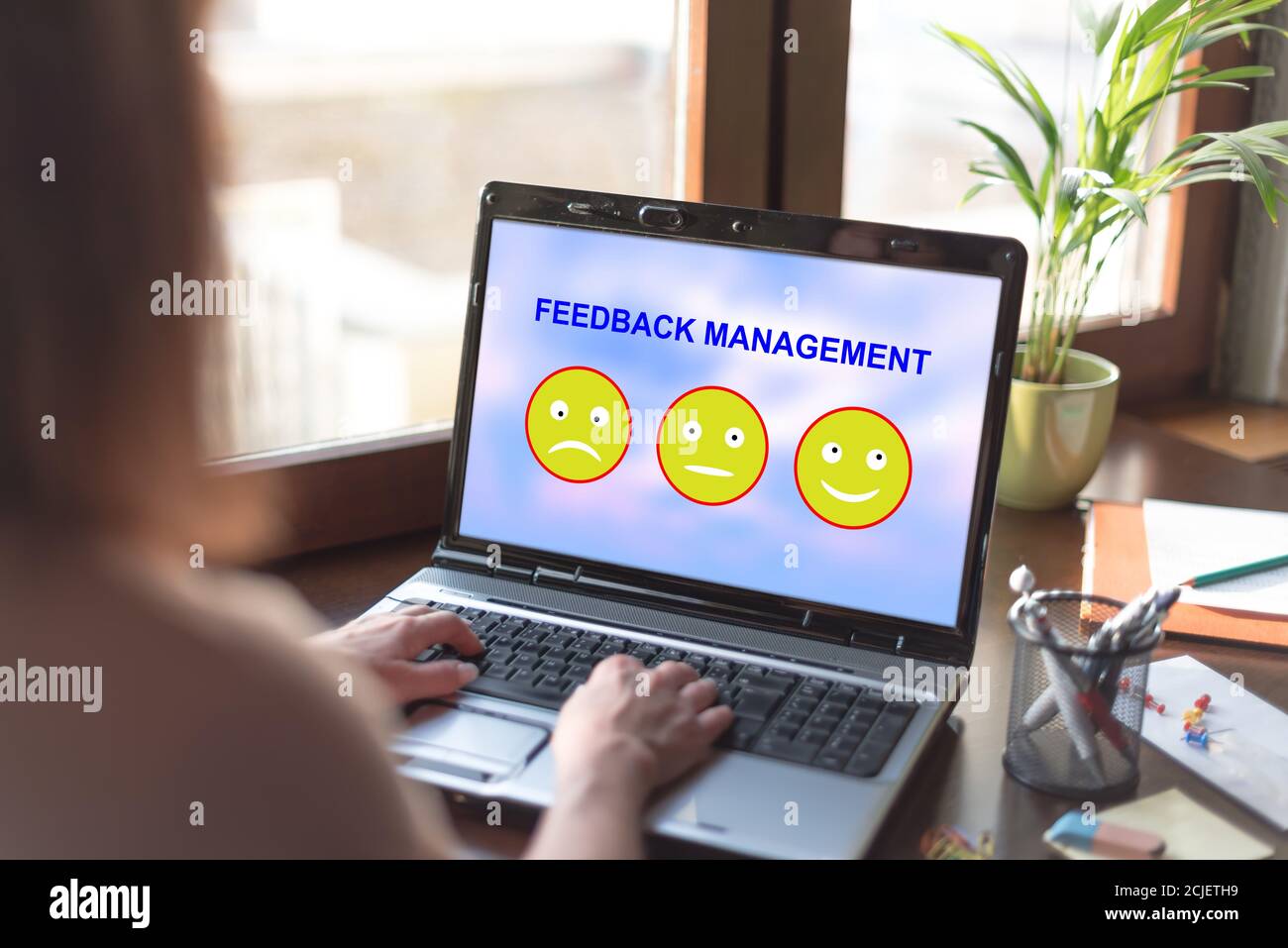 Laptop screen displaying a feedback management concept Stock Photo - Alamy