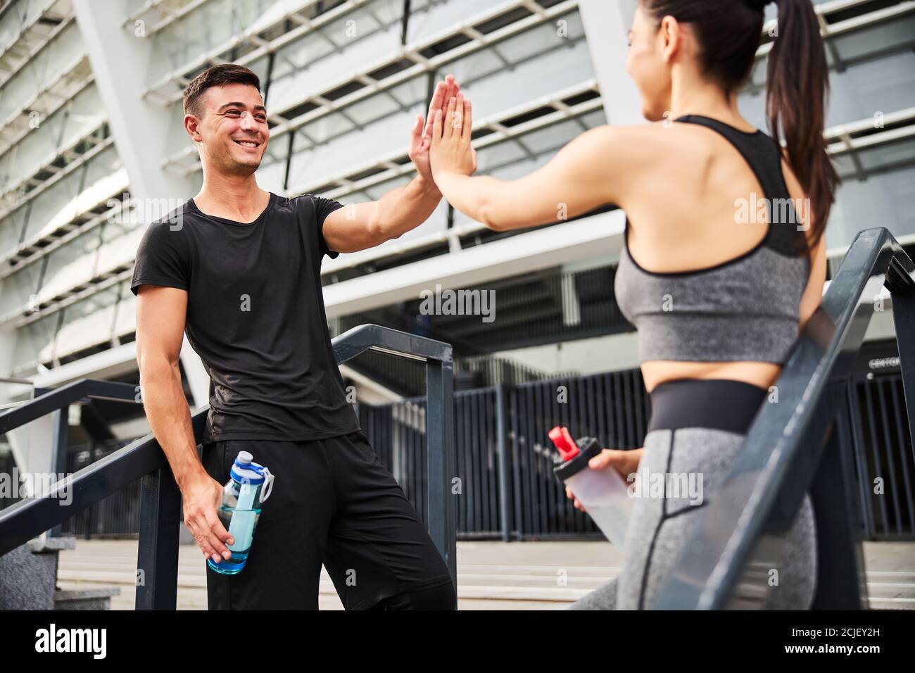 Cheerful sporty couple going to training together Stock Photo - Alamy