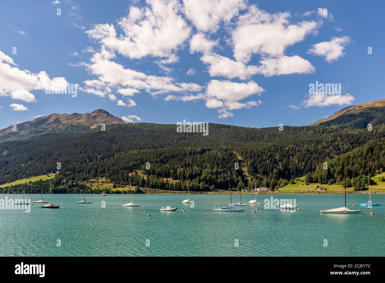 Boats moored on the waters of Lake Resia, near the village of Resia ...