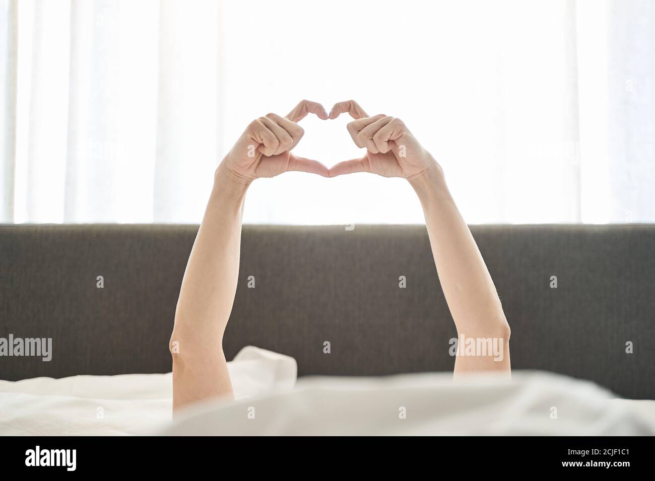 Woman showing heart shape symbol hi-res stock photography and images ...