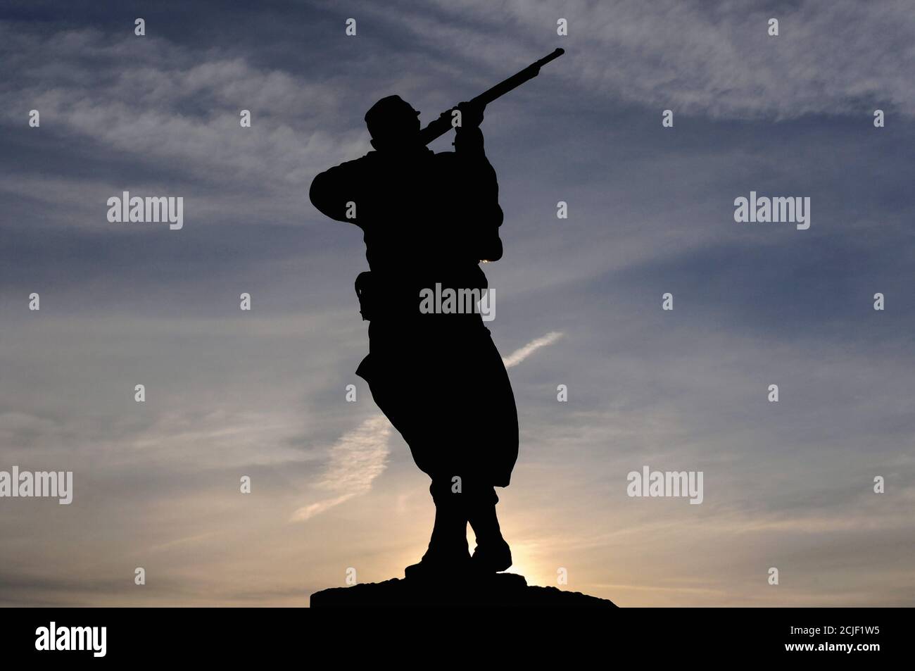 Bronze statue of a French infantryman or poilu silhouetted against the ...