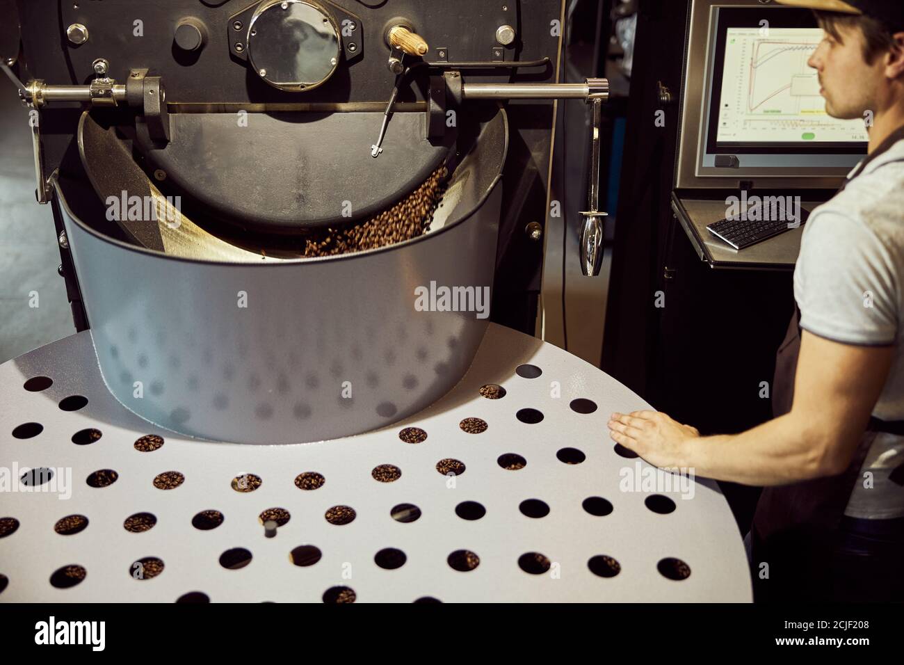 Professional roaster controlling work of coffee roasting machine Stock ...