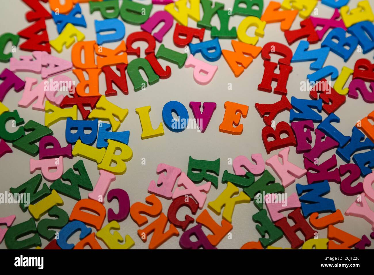 Closeup of colorful wooden letters forming the word "LOVE" on the table ...
