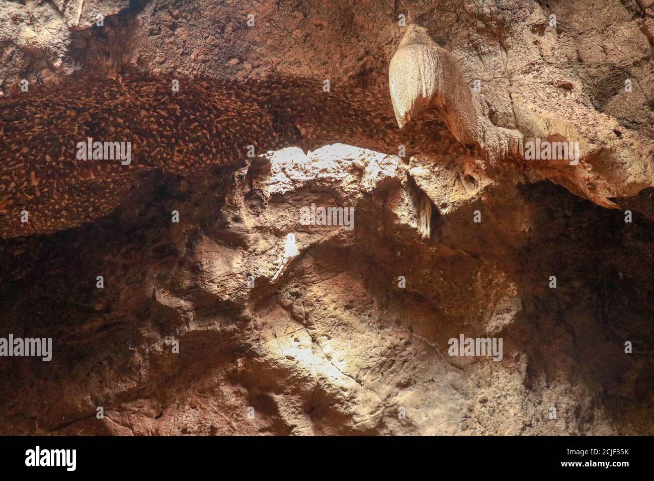 Stalactites hanging from the ceiling of the cave underground. Mountain ...