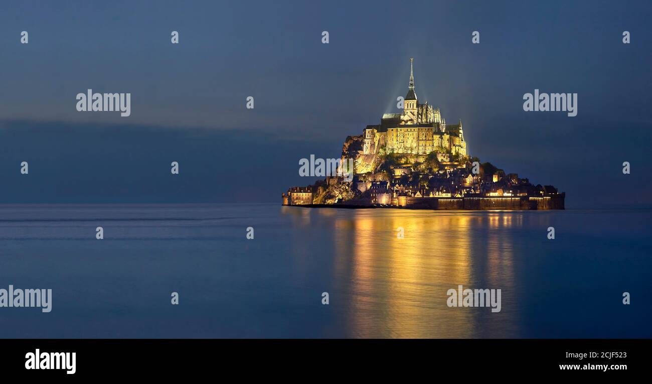 Scenic view of the tidal island of Mont Saint Michel at night at high ...
