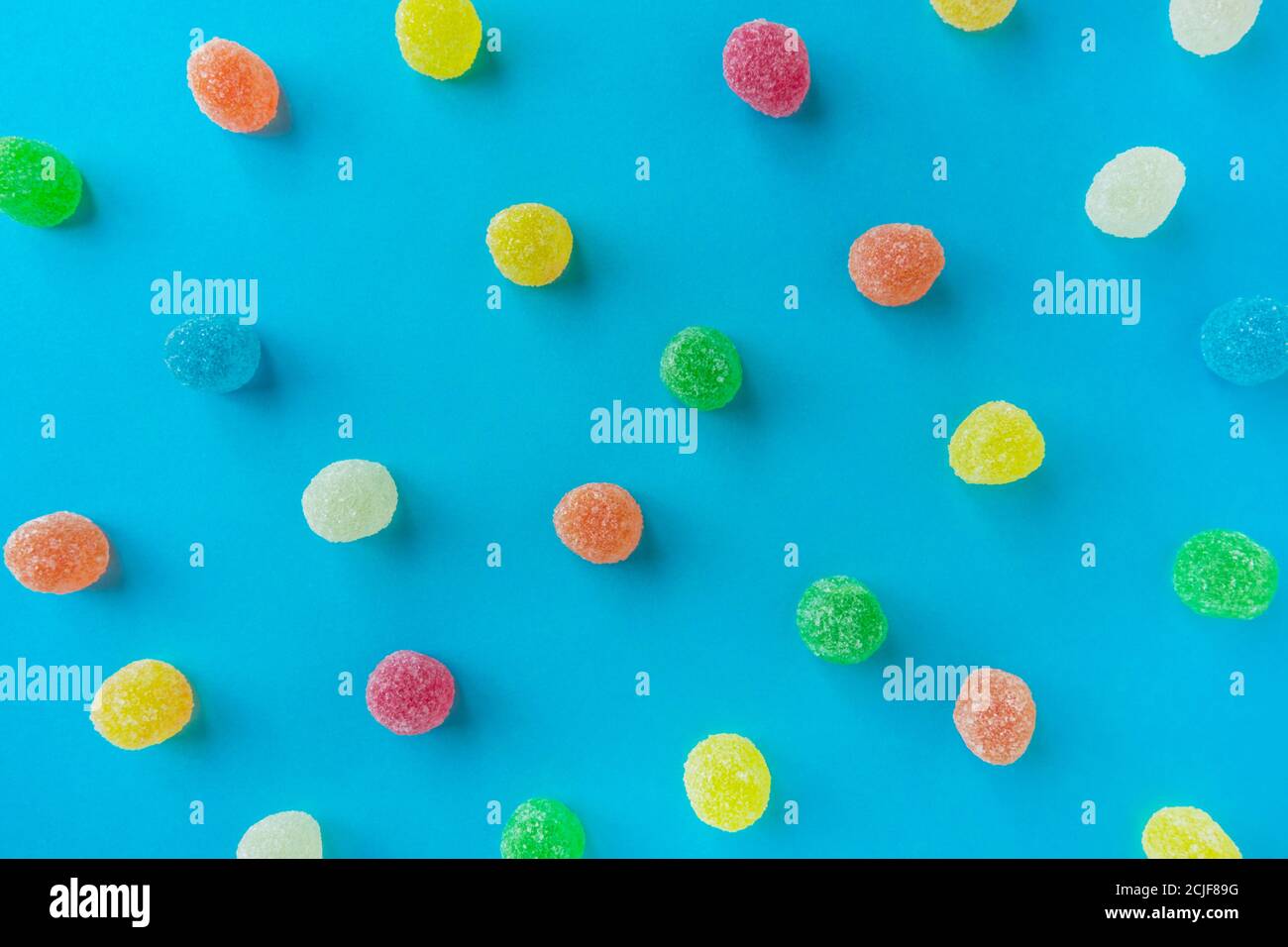 Candy pattern on blue background. Flat lay layout Stock Photo - Alamy
