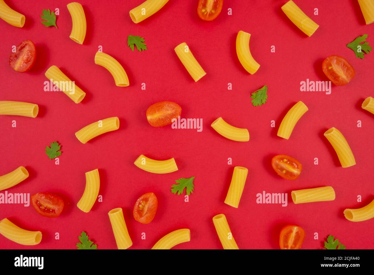Macaroni, tomatoes and parsley pattern on red background. Italian food ...
