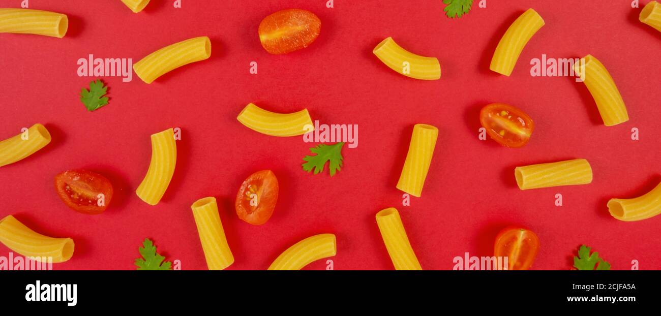 Macaroni, tomatoes and parsley pattern on red background. Italian food ...