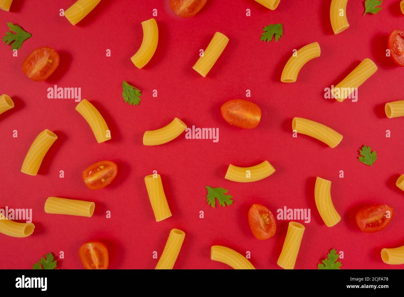 Macaroni, tomatoes and parsley pattern on red background. Italian food ...