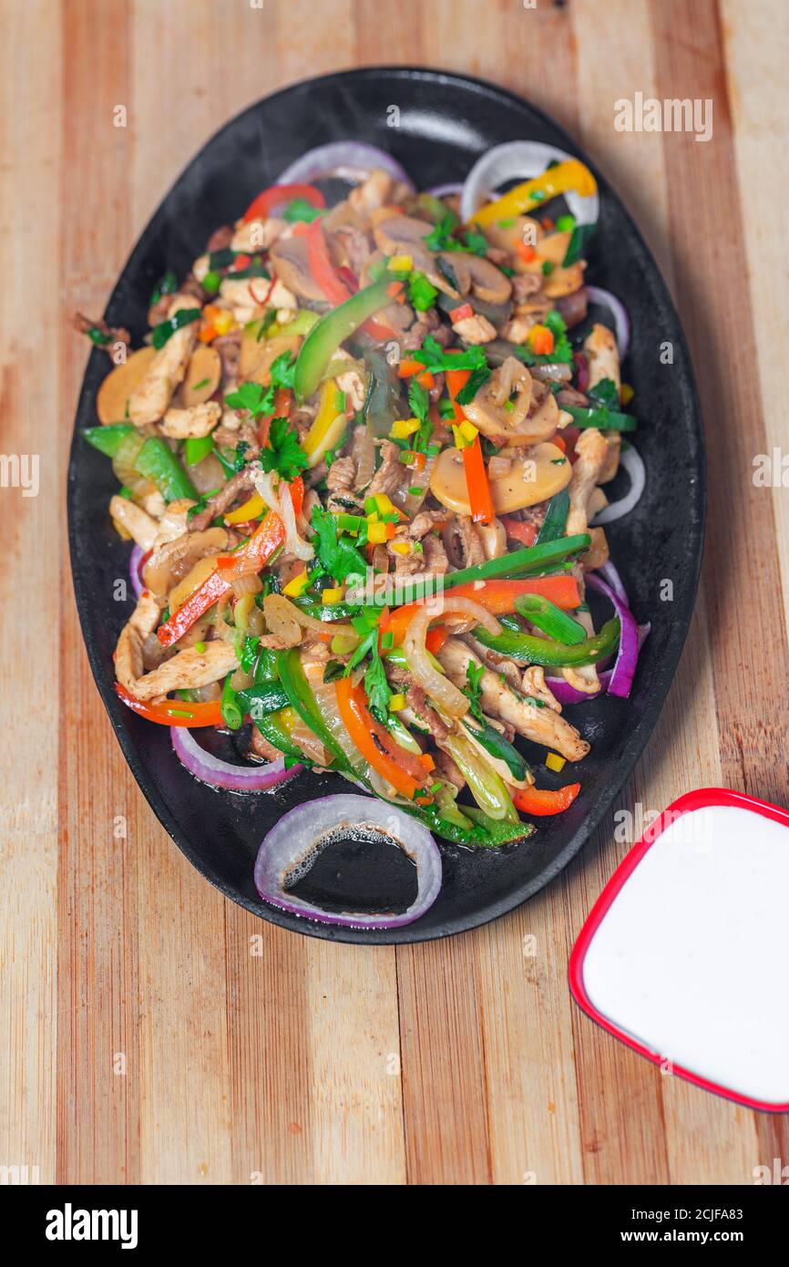Chicken mushroom and capsicum stir fry recipe served on a sizzling ...