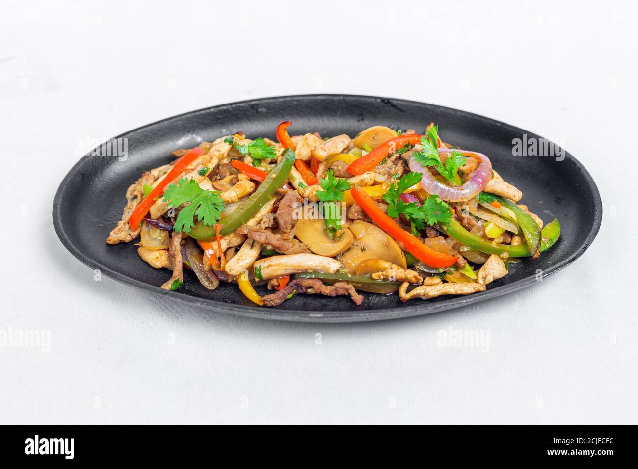 Chicken mushroom and capsicum stir fry recipe served on a sizzling ...