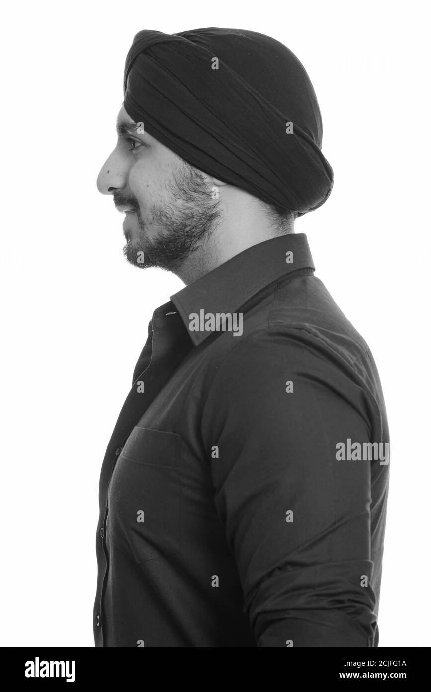 Profile view of young happy Indian Sikh man smiling Stock Photo - Alamy