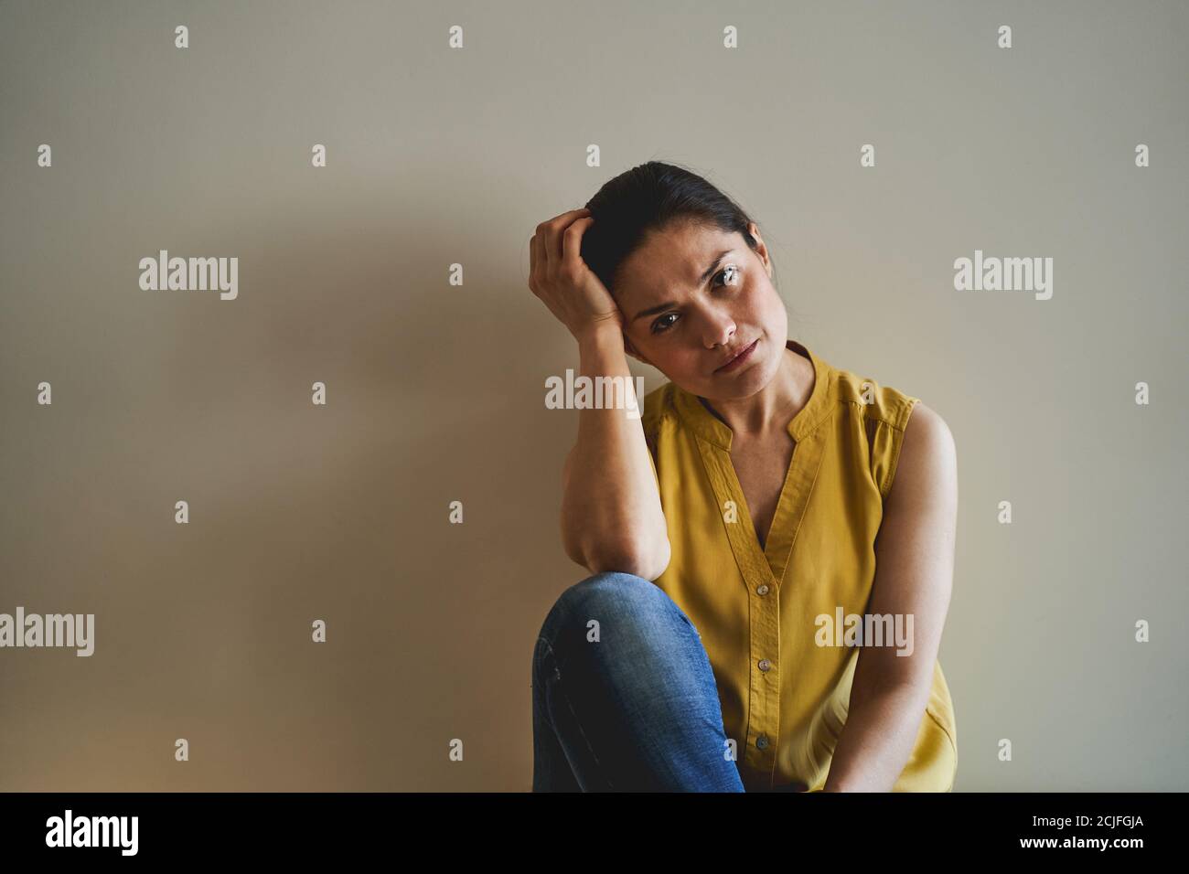 Low-spirited female staring in front of her Stock Photo - Alamy