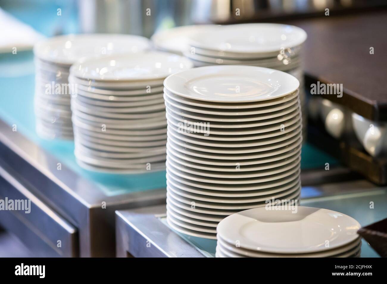 Stacks of empty white plates on a restaurant table Stock Photo - Alamy
