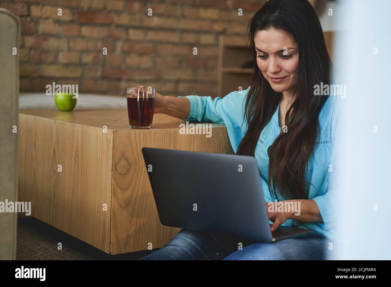 Concentrated lady writing an email on her computer Stock Photo - Alamy