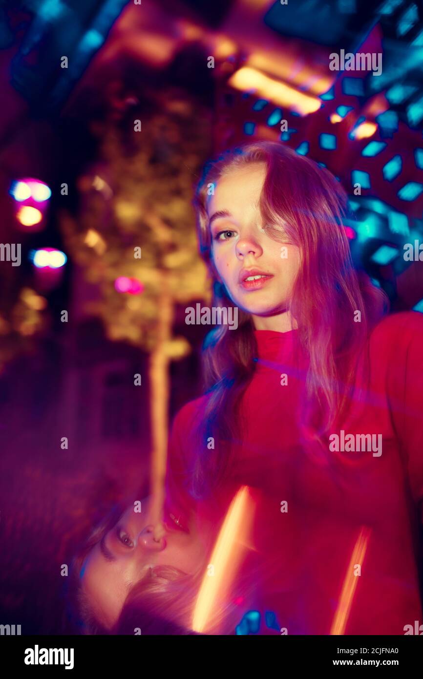 Beautiful. Cinematic portrait of stylish young woman in neon lighted ...