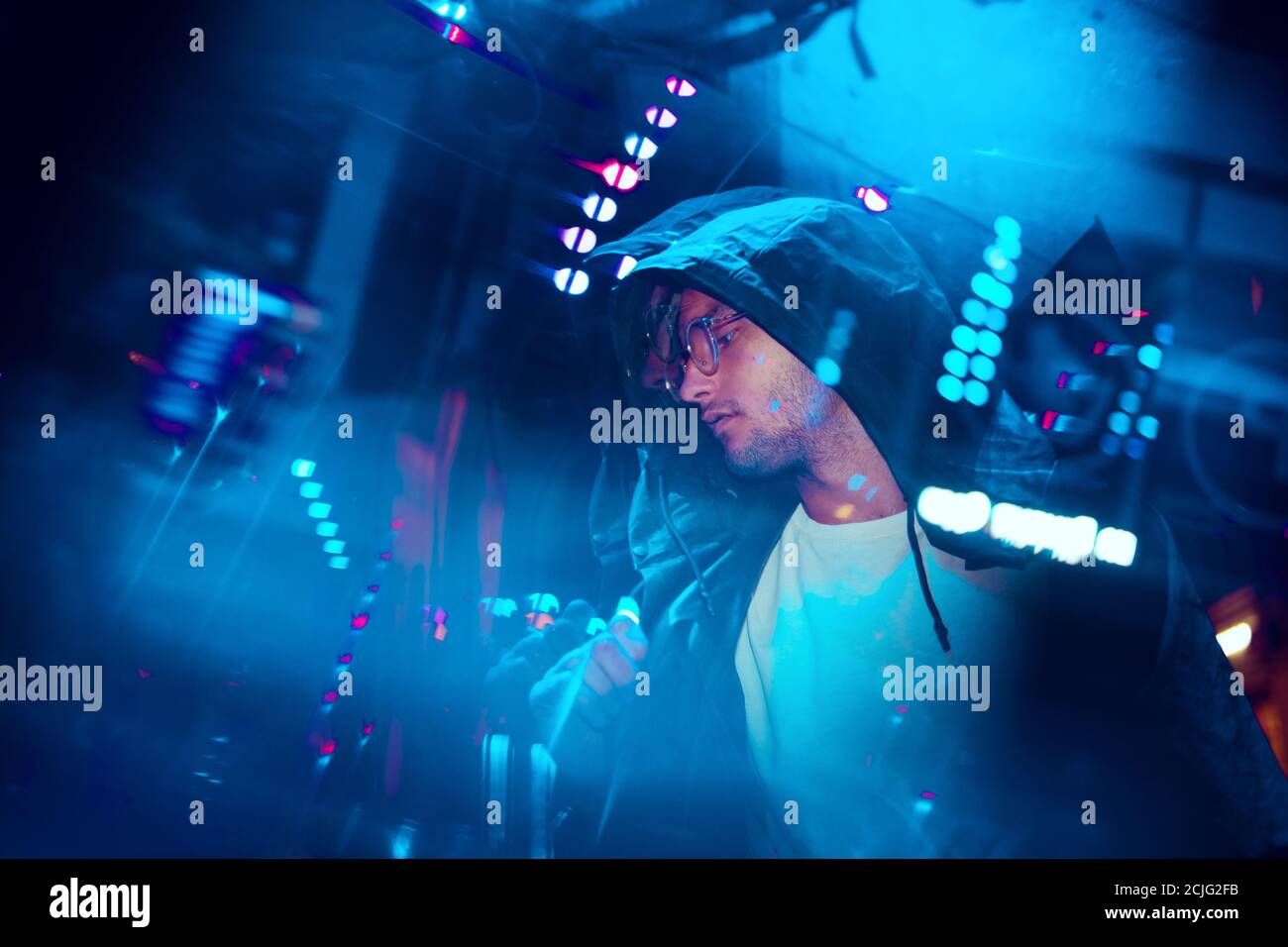 Blue cold. Cinematic portrait of stylish young man in neon lighted room ...