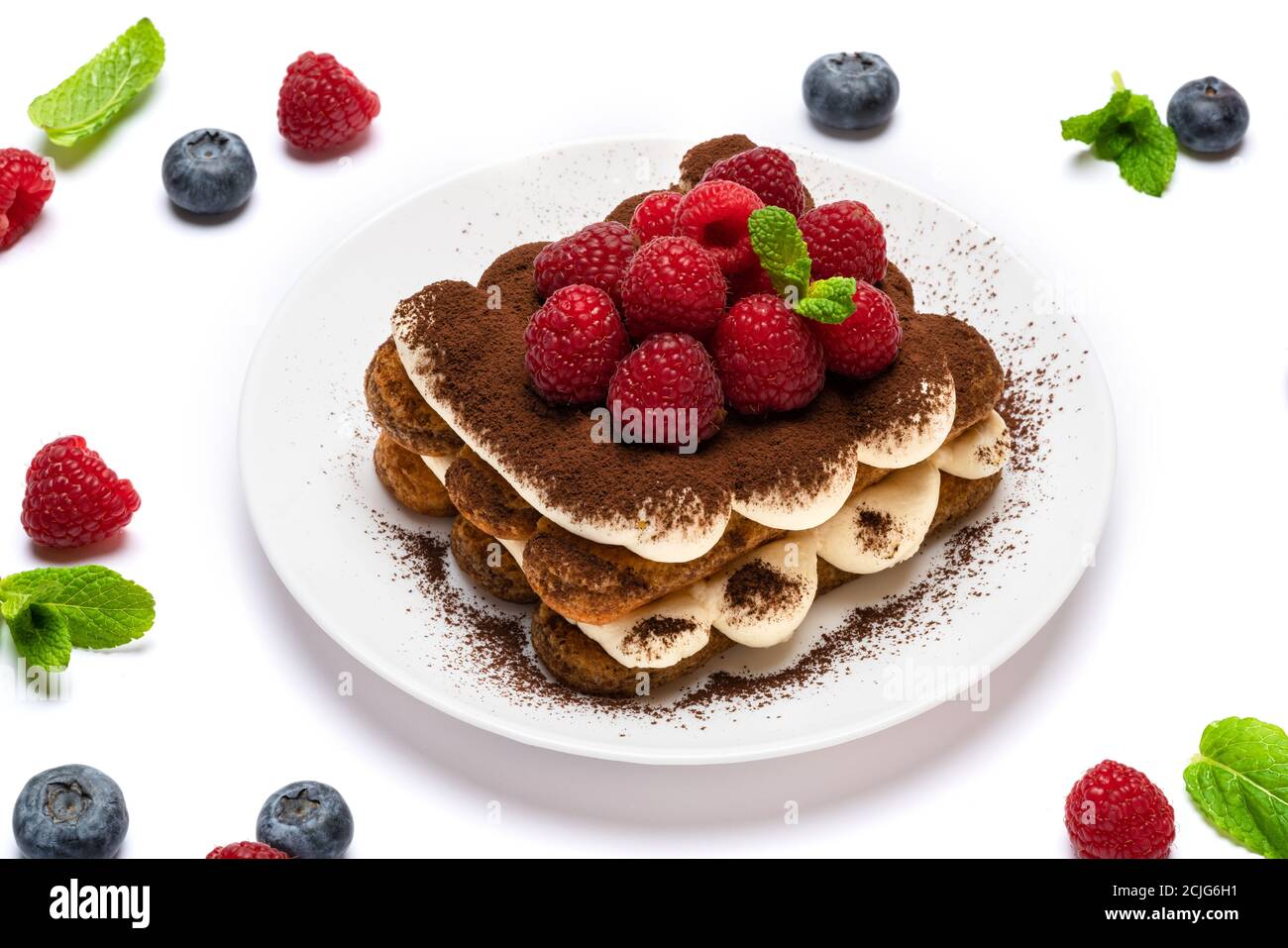 portion of Classic tiramisu dessert with raspberries and blueberries on ...