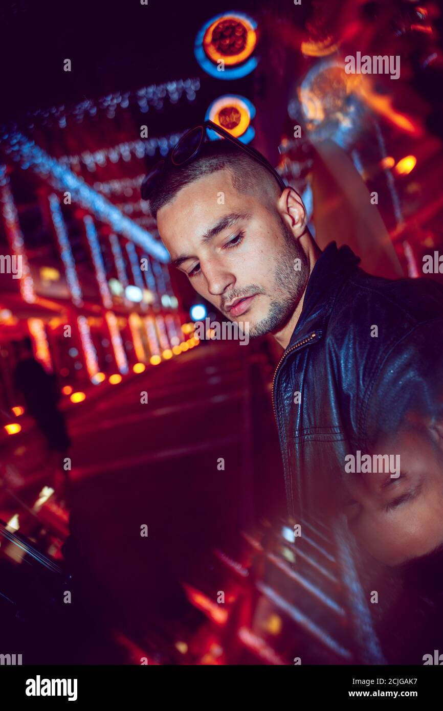 Stylish one. Cinematic portrait of stylish young man in neon lighted ...