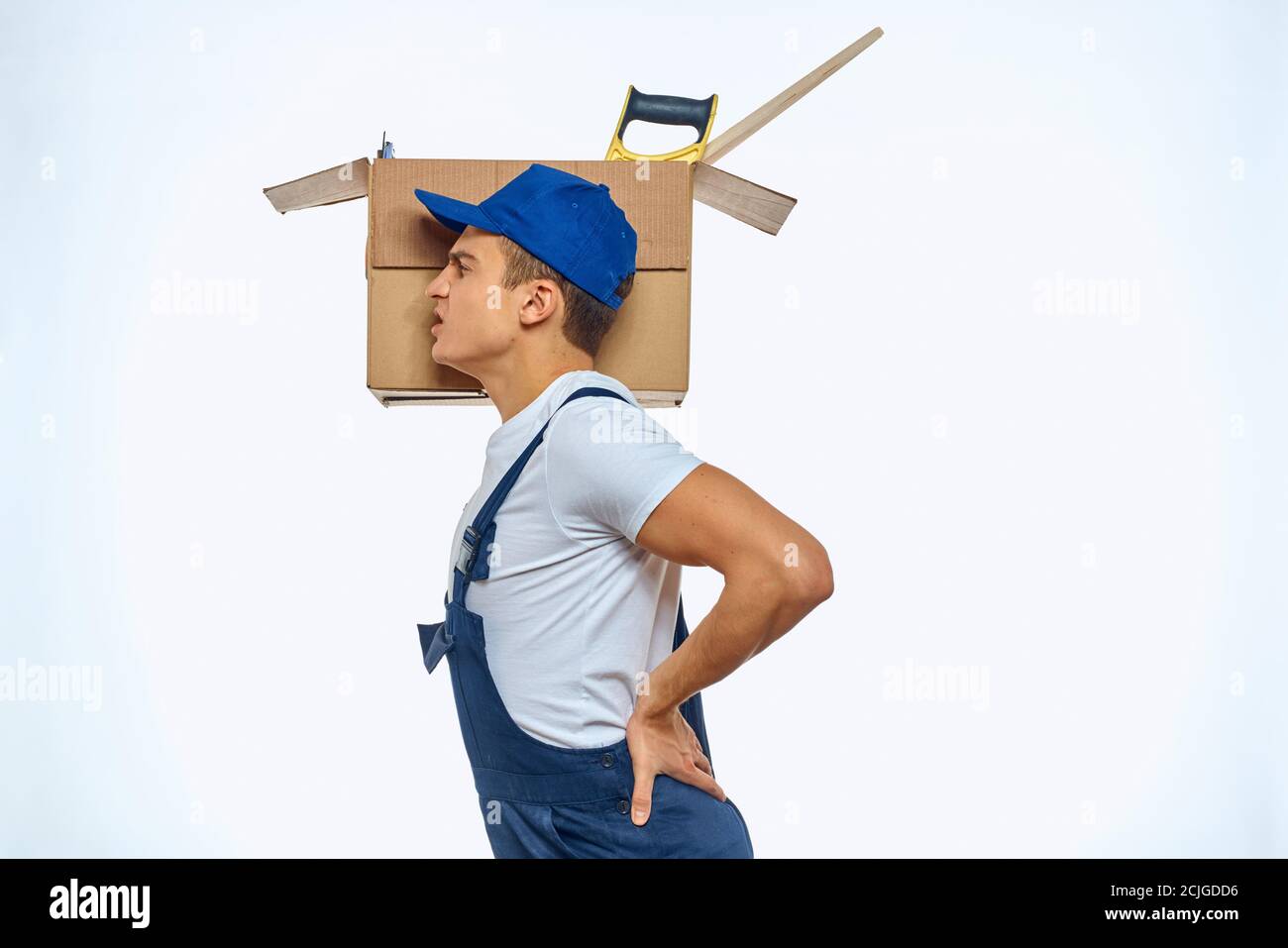 A man in a working uniform with a box in his hand loading a delivery ...