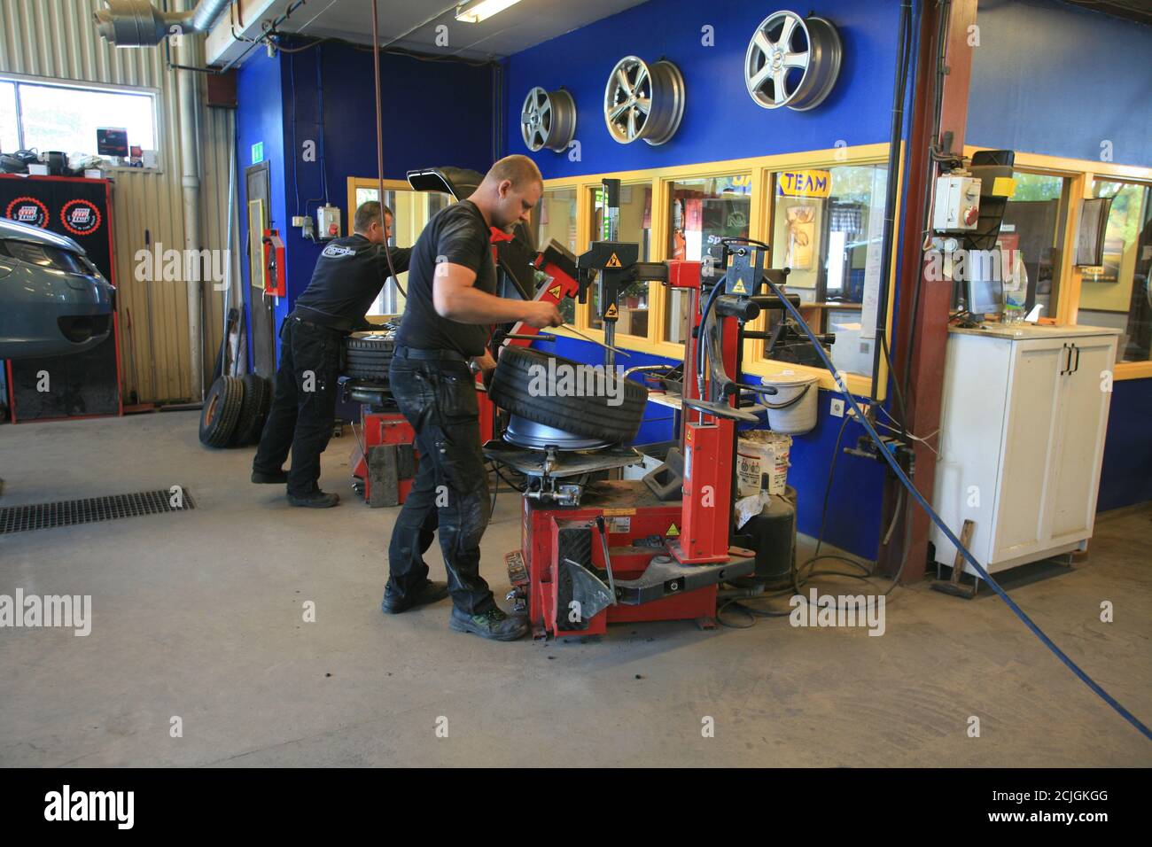 TYRE WORKSHOP with car in the lift that will have to change tires Stock ...