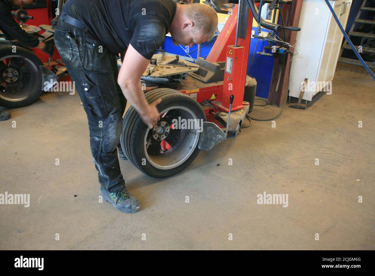 TYRE WORKSHOP with car in the lift that will have to change tires Stock ...