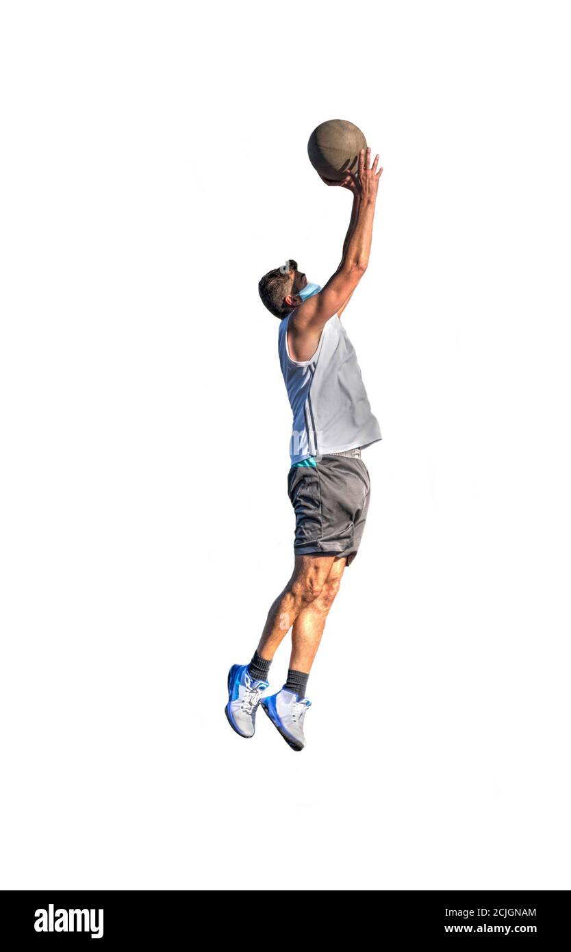 Basketball player with virus protection mask shooting on white ...