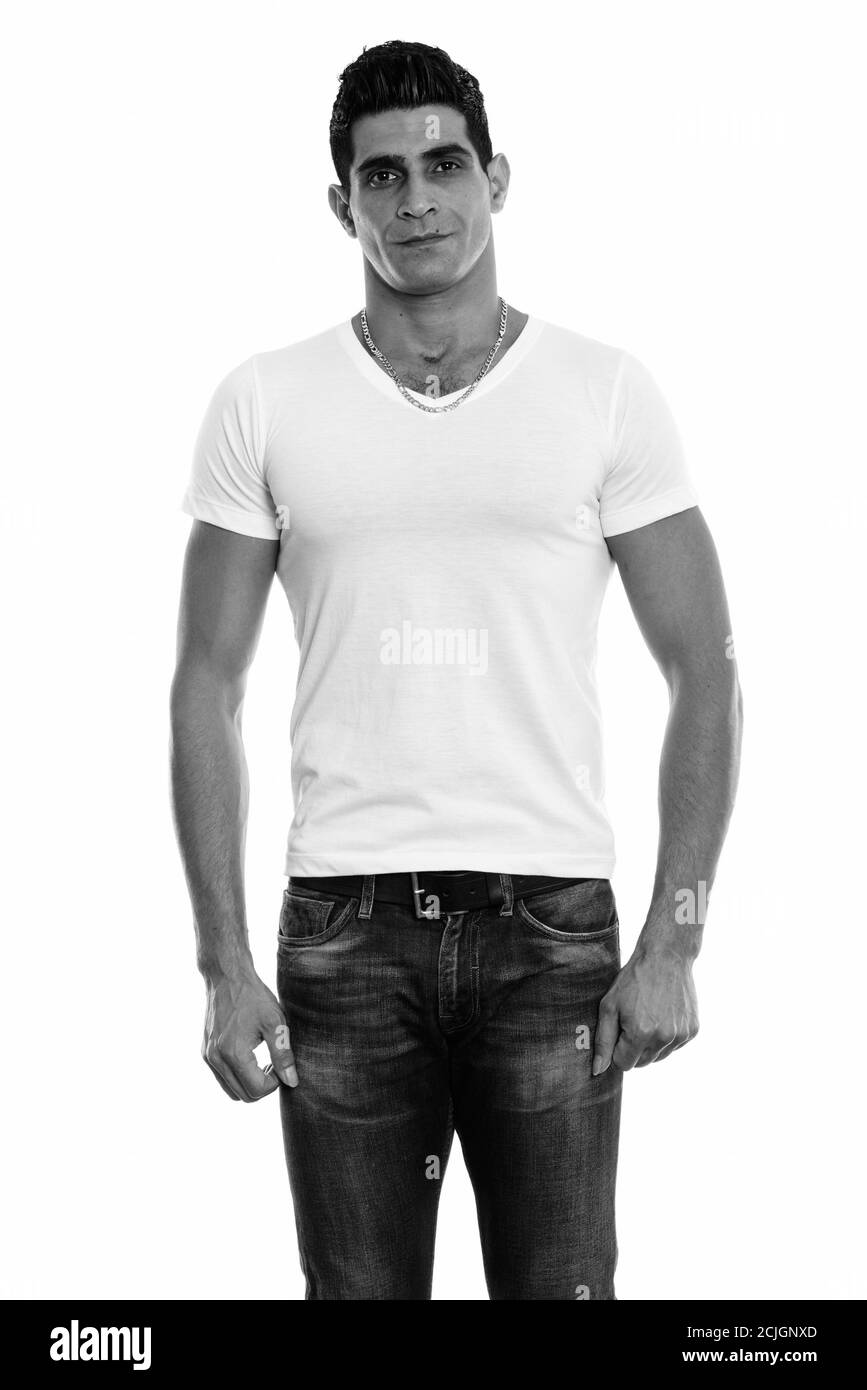 Studio shot of young muscular Persian man standing Stock Photo - Alamy