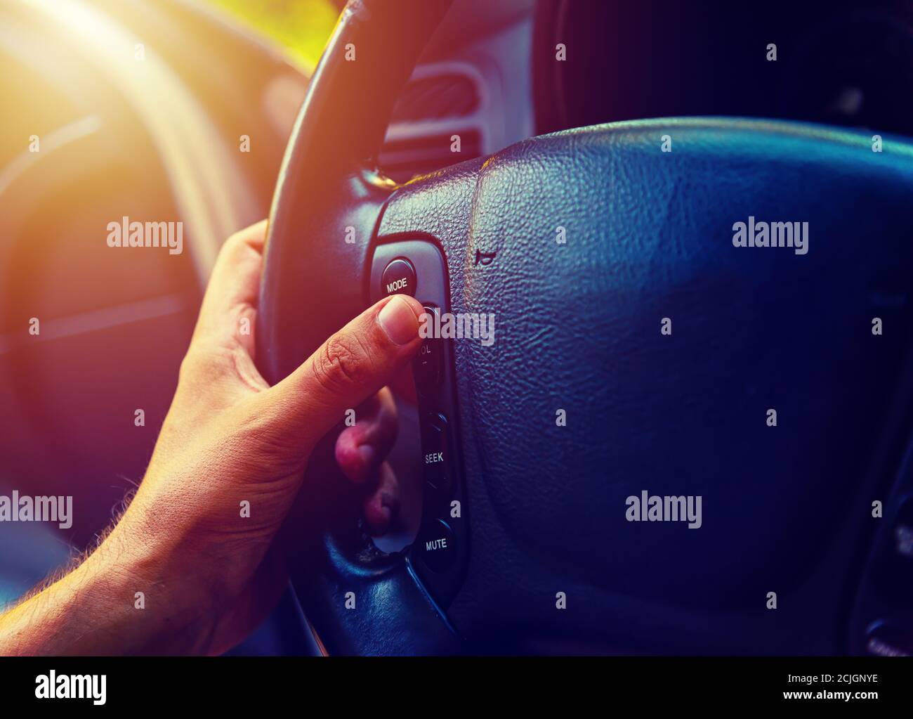 Close up of a man setting stereo volume by pressing a button on ...