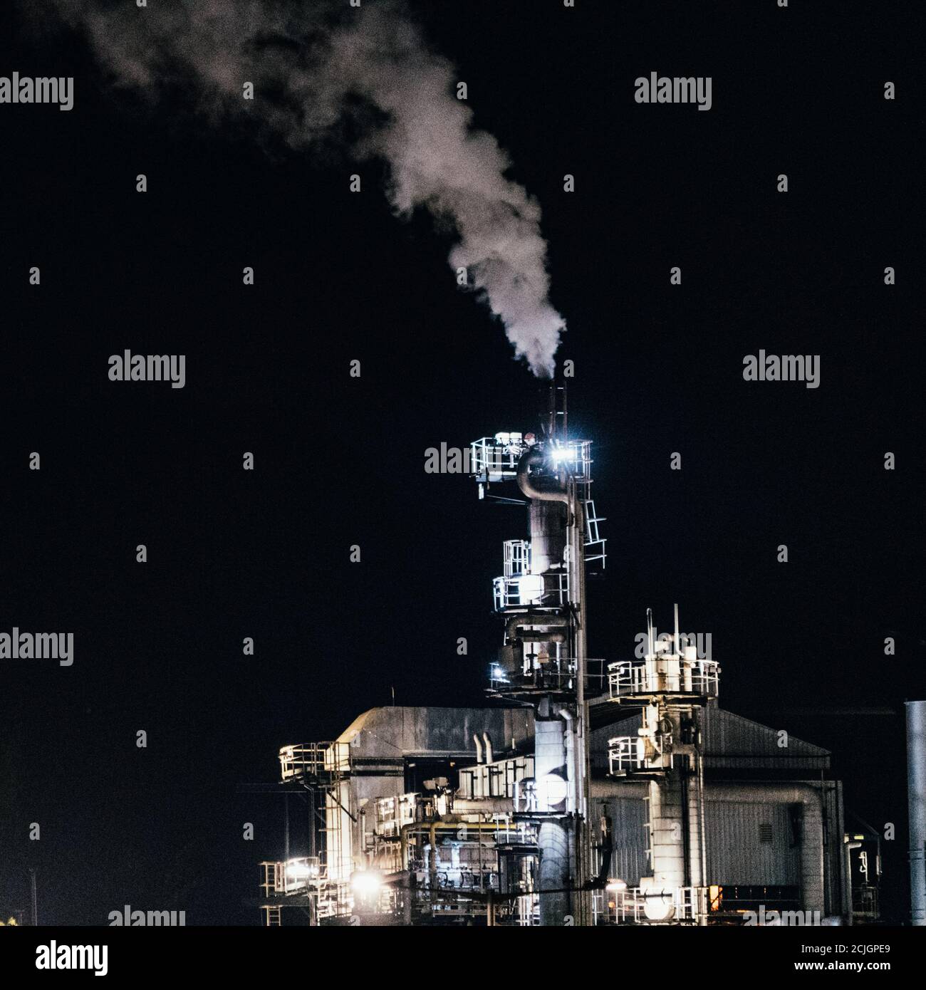 Beautiful shot of an oil refinery with light at night Stock Photo - Alamy