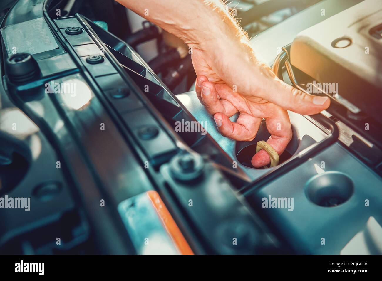 Close up of a man checking engine oil dipstick of a modern car Stock ...