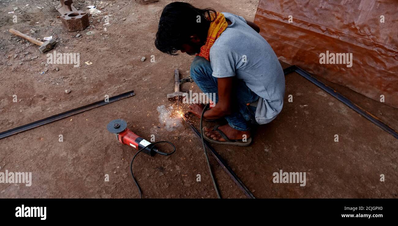 DISTRICT KATNI, INDIA - JULY 29, 2019: An indian blacksmith doing ...
