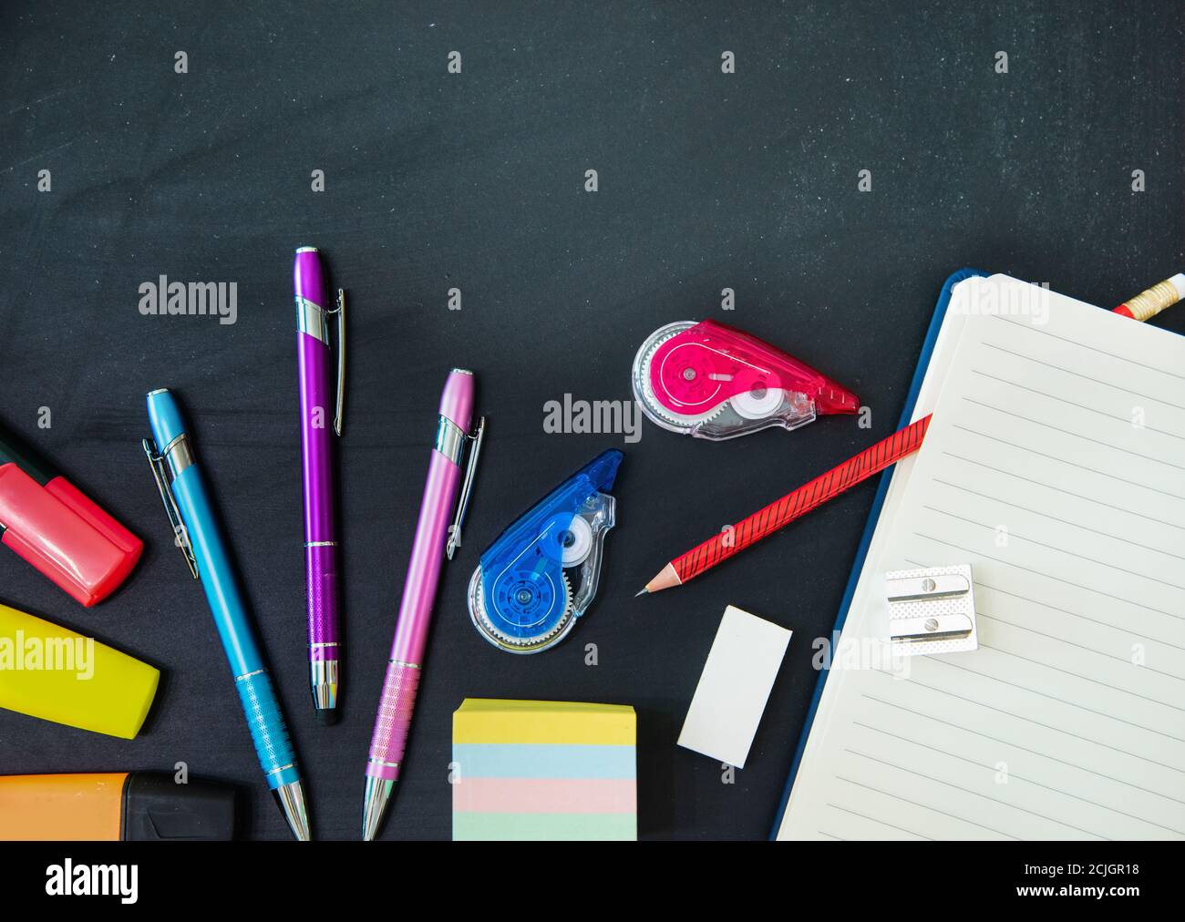 Pens and other school objects on a chalkboard seen from above Stock ...
