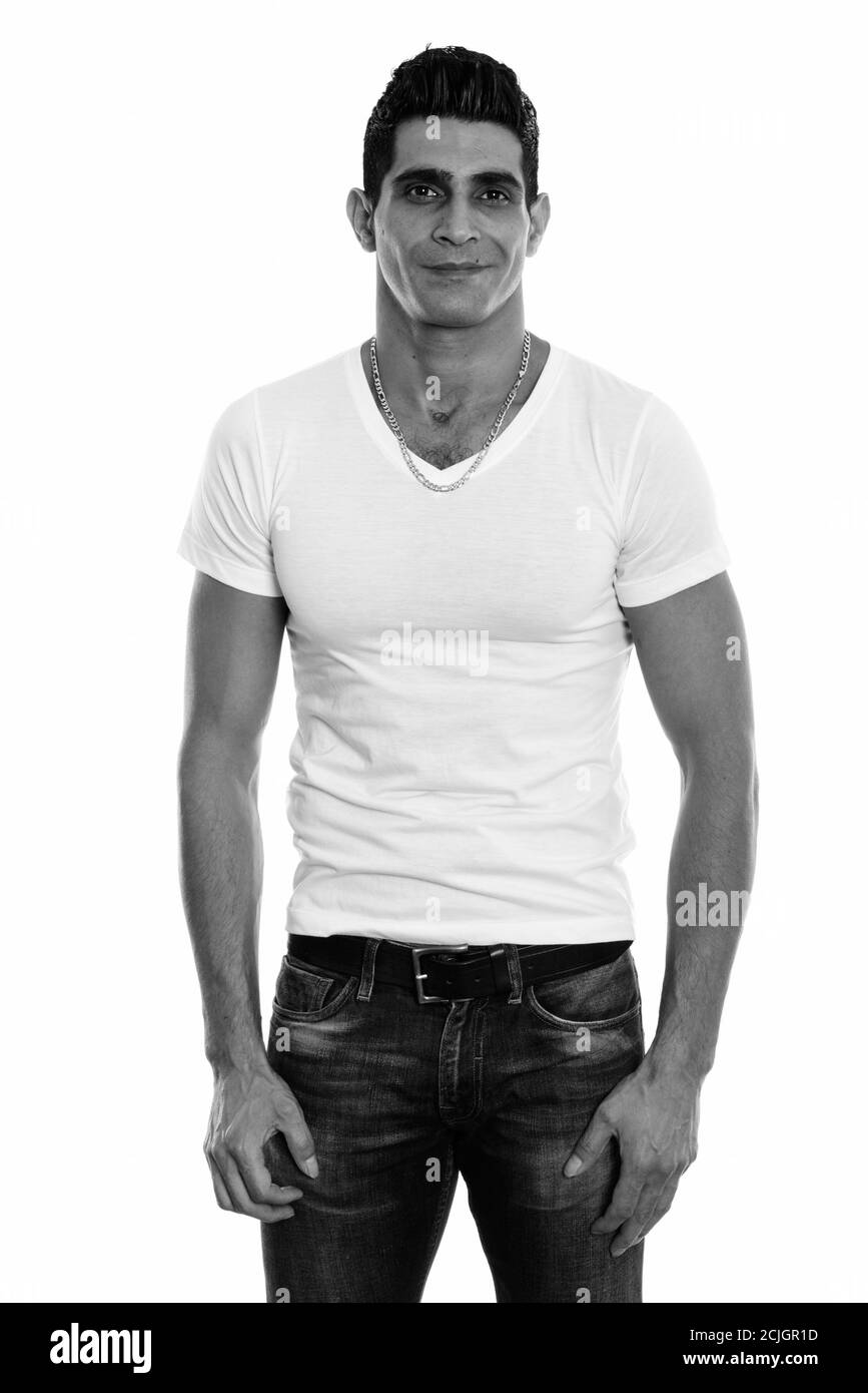 Studio shot of young muscular Persian man standing Stock Photo - Alamy